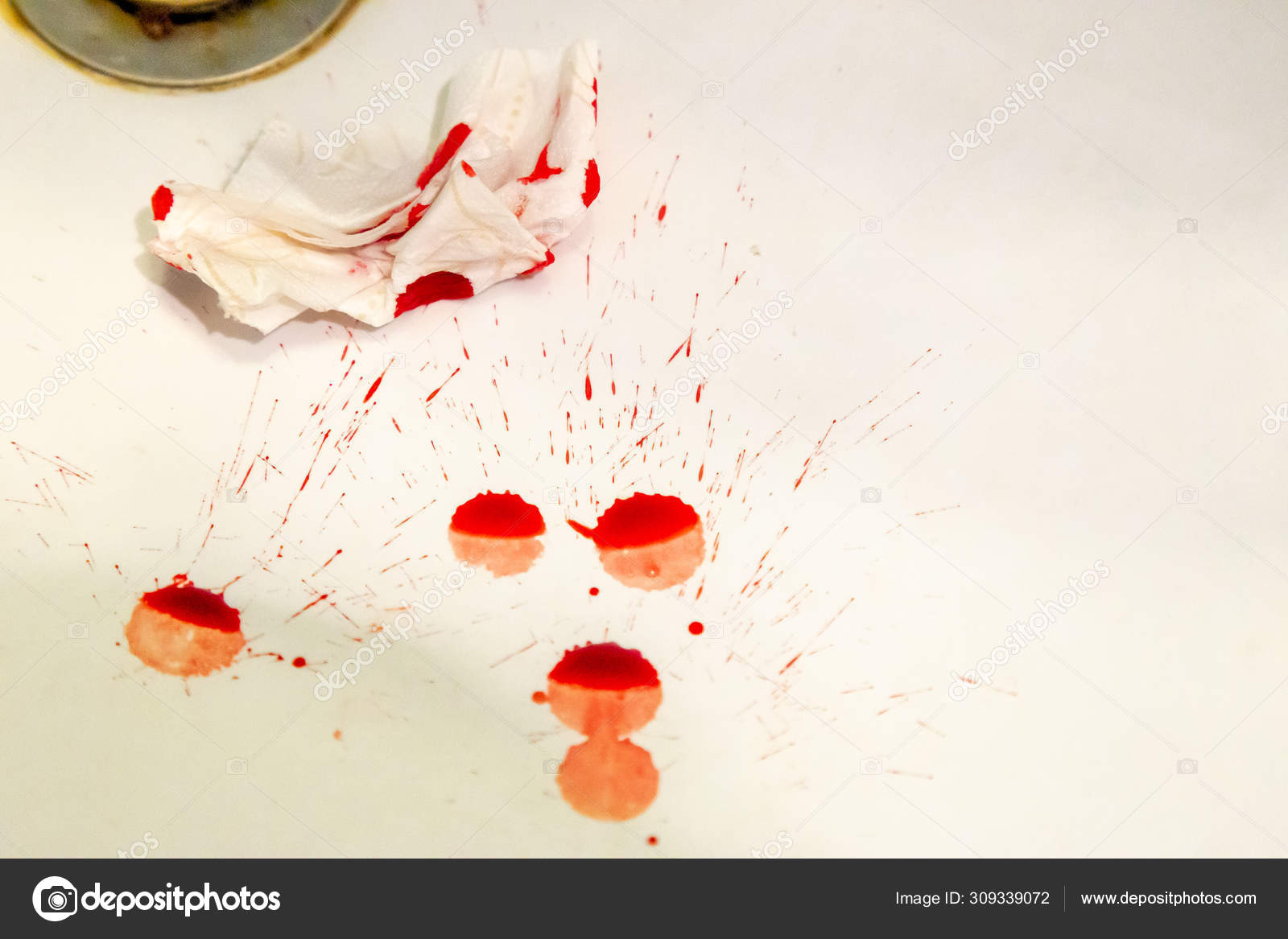 Real drops of blood fallen on a sink along with napking in attem ...
