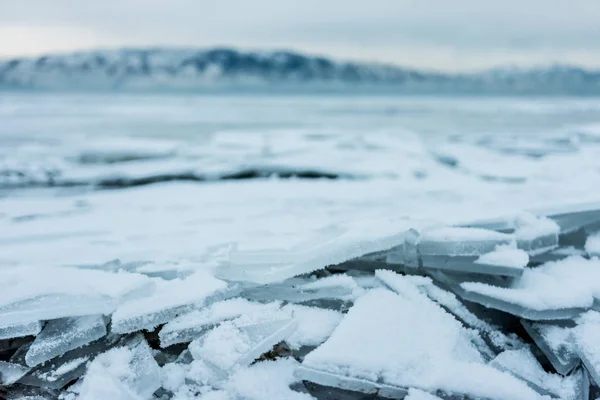Shards of cracked ice on shore of frozen lake - Stock Image - Everypixel