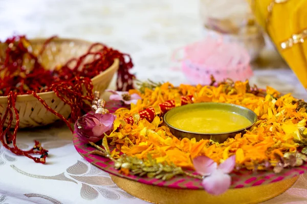 Traditional Haldi turmeric kept on a flower plate for the hindu ...