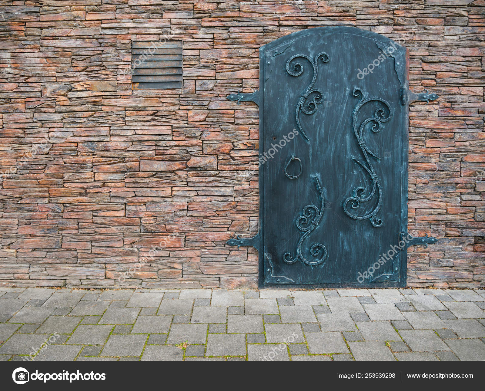 Old iron door with a stone wall — Stock Photo © Liaks #253939298