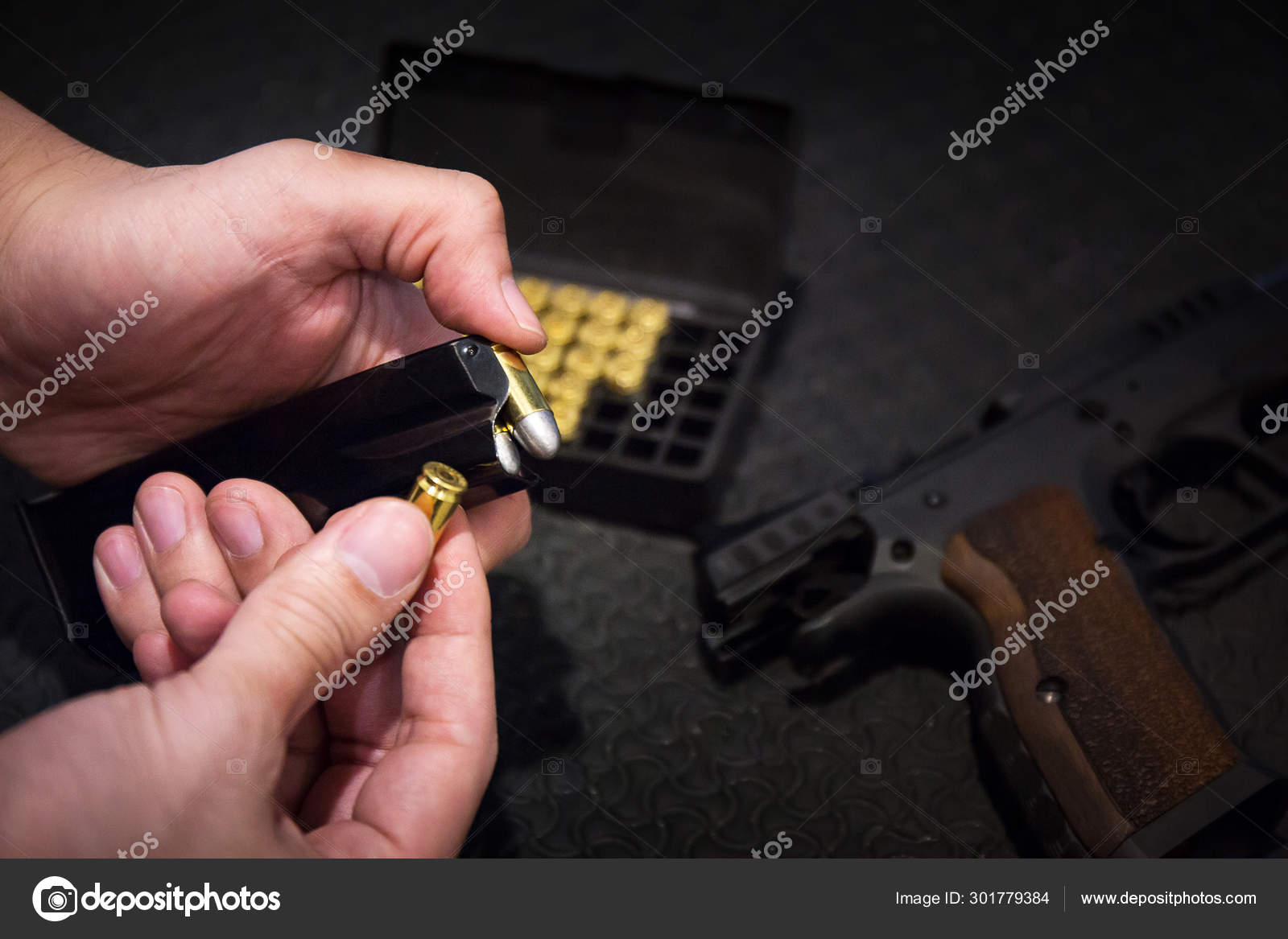 Gunner reload his pistol magazine, gun weapon, bullet from bullet block ...