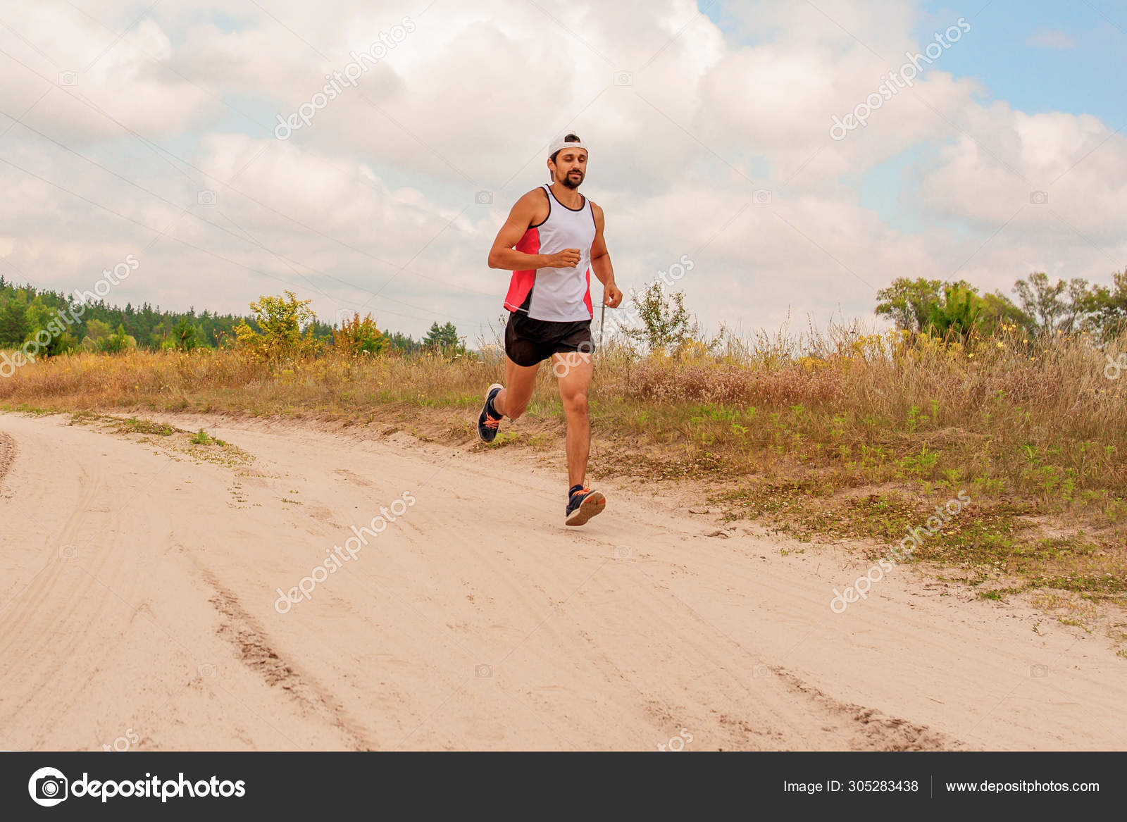 Man running outdoors with a beard in a sports uniform in nature, day ...