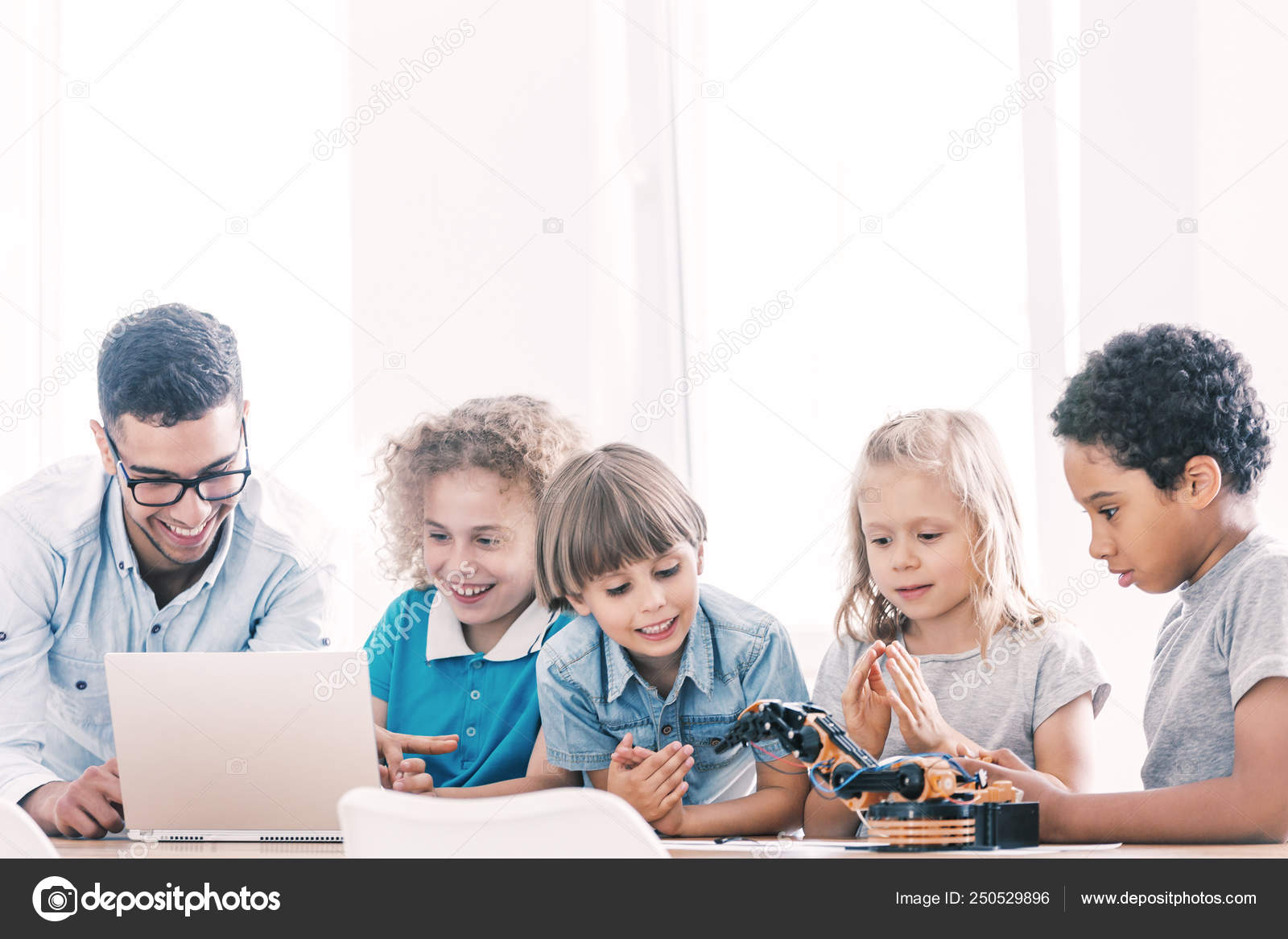 Primary school kids learning about computers, robots and coding in an ...