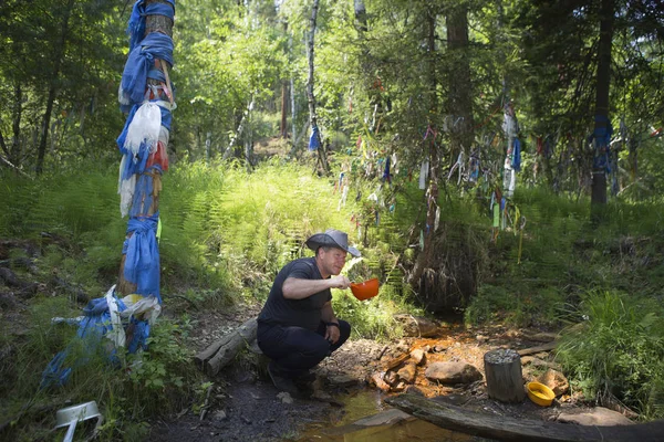 A holy source of drinking. Mineral water flows in a stream in the ...
