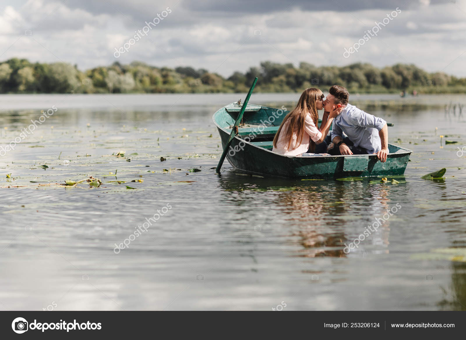 Just relaxing. Beautiful young couple enjoying romantic date while ...