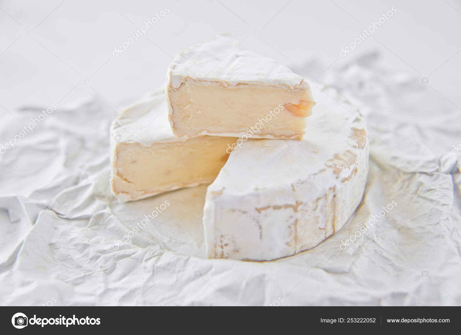 Brie cheese on white paper. White background, side view, close-u Stock ...