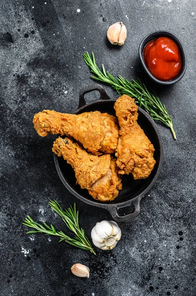 Spicy Deep Fried Breaded Chicken drumsticks. Black background. Top view ...
