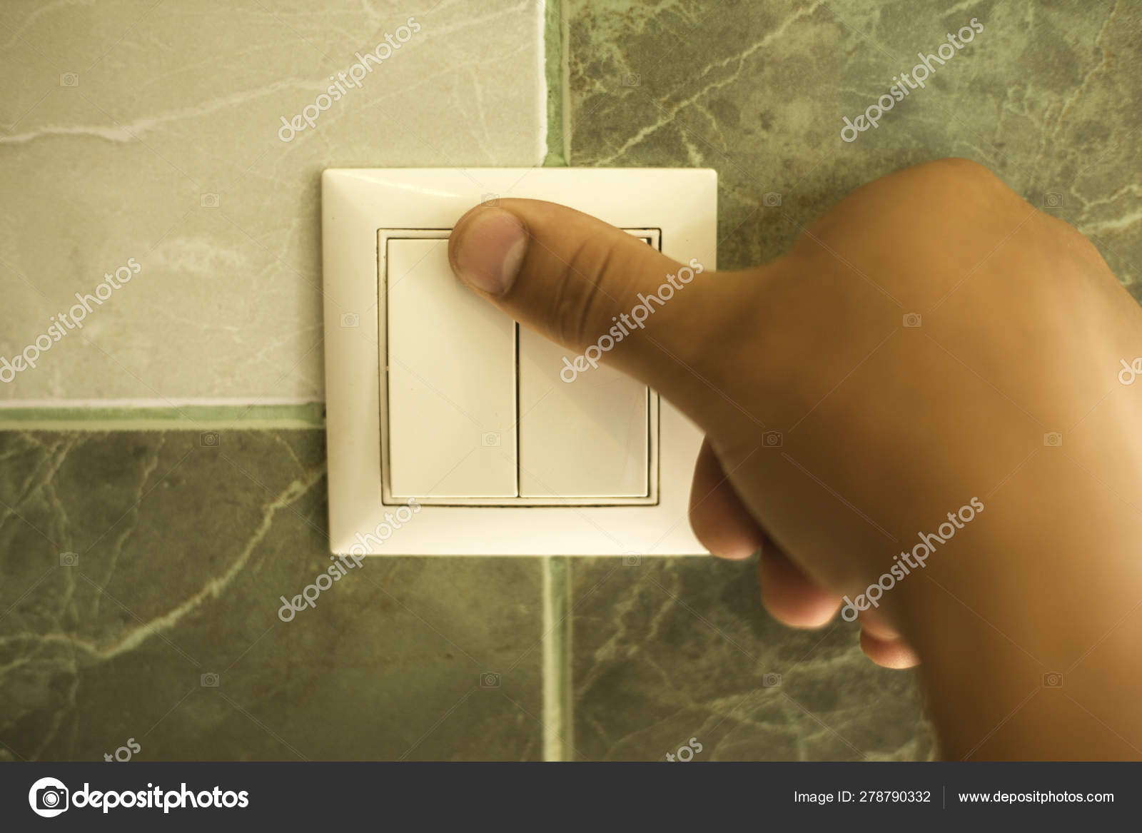 Hand extinguishes the light in the bathroom using a wall switch Stock ...