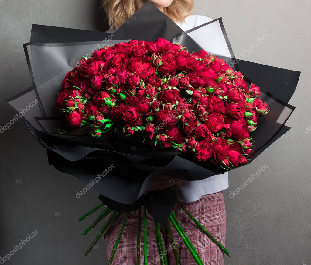 un gran ramo exuberante de rosas rojas del jardín y brotes en papel de ...