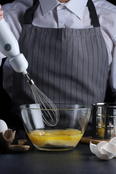Chef with mixer in hands cooking pie with ingridients on table - Stock ...
