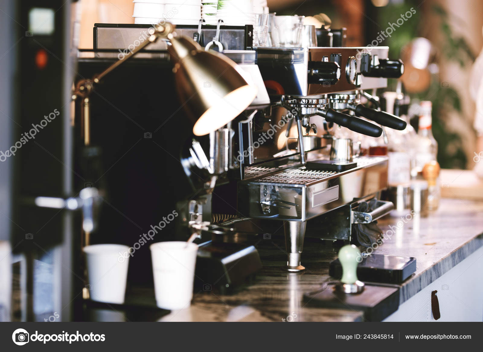 A modern expensive coffee machine is shown in work in modern cozy ...