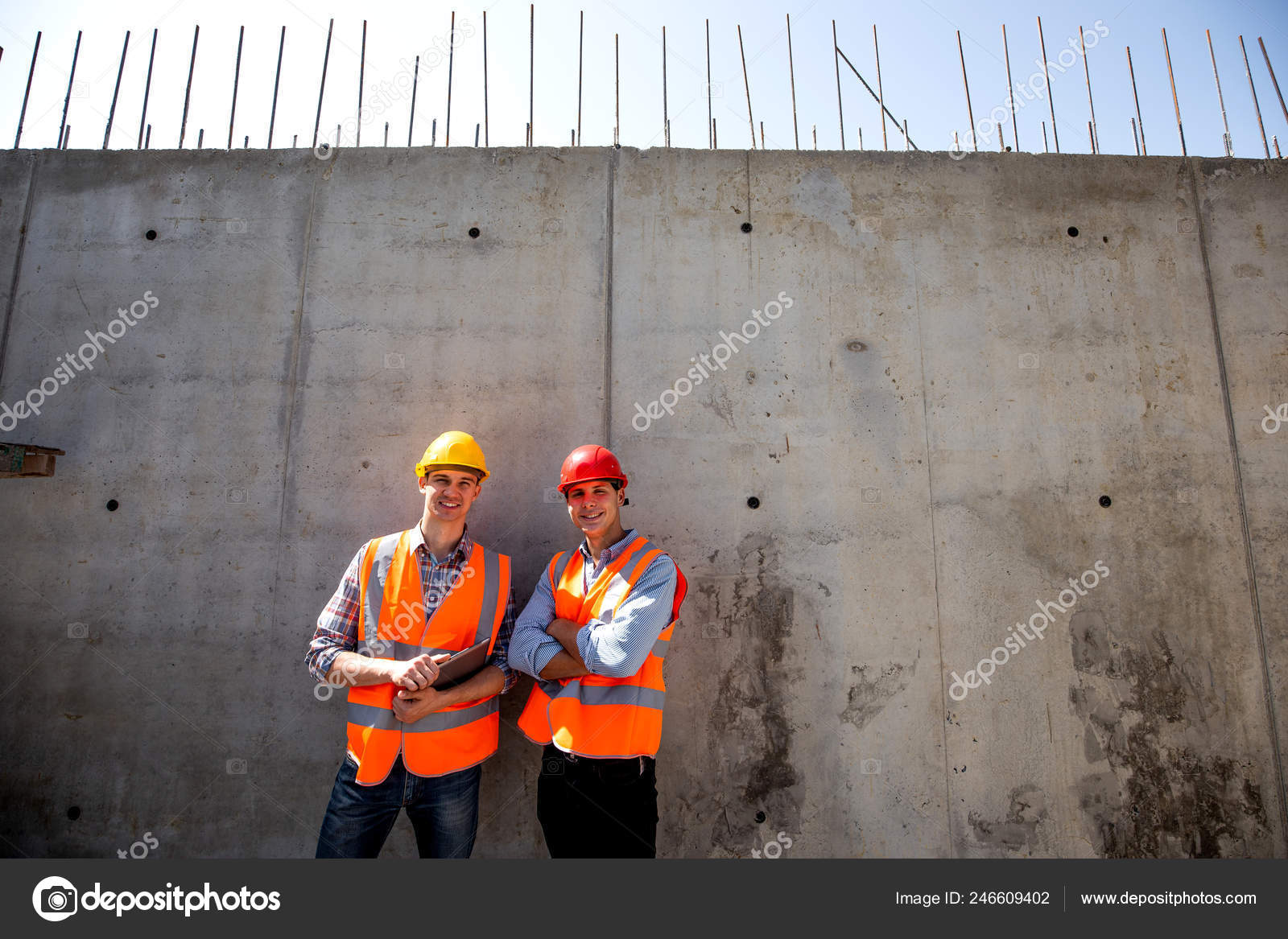 Structural engineer and architect dressed in orange work vests and ...
