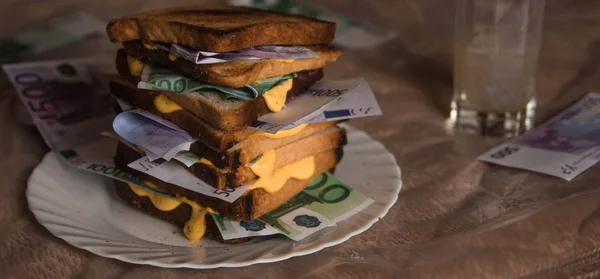 sandwich of bread and money Euro dollars bills with cheese sauce. money ...