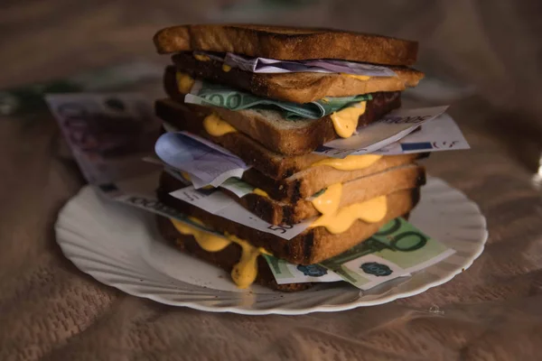 sandwich of bread and money Euro dollars bills with cheese sauce. money ...