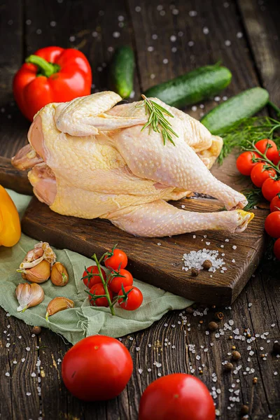 raw homemade chicken, yellow broiler, meat with skin, spices and coarse ...