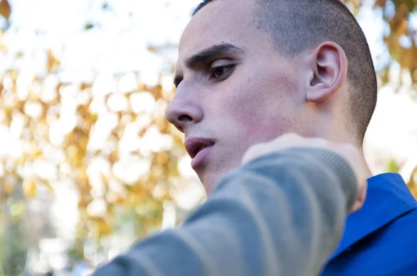 Aggression between young adults. They are fighting in city park ...