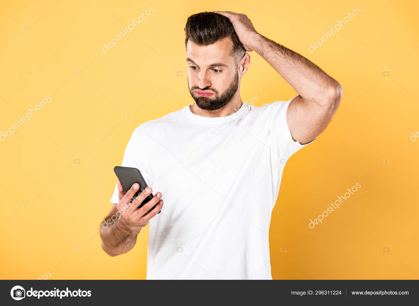 Confused Handsome Man White Shirt Using Smartphone Isolated Yellow