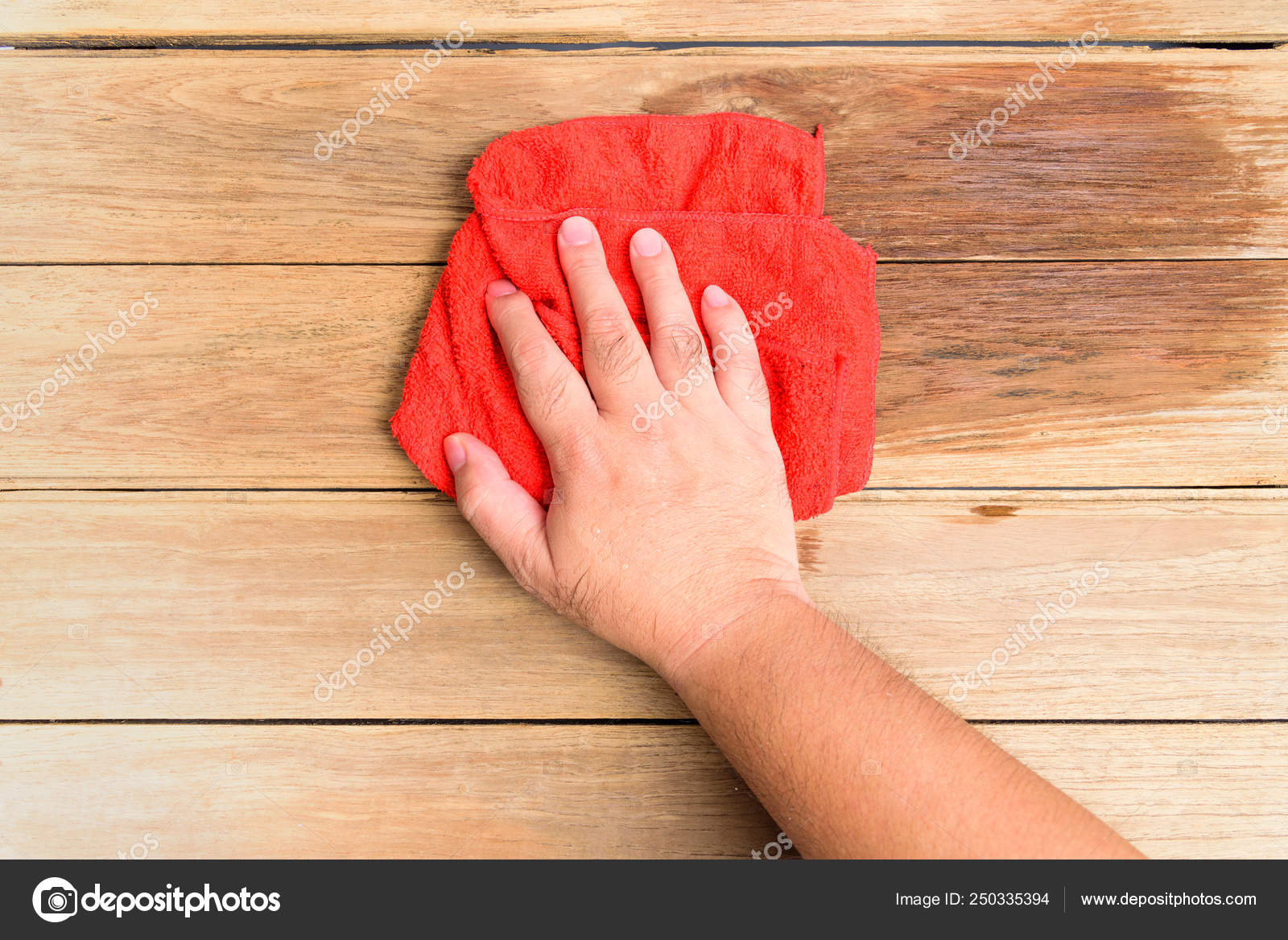 La mano de un hombre usando trapos rojos limpie el suelo de madera ...