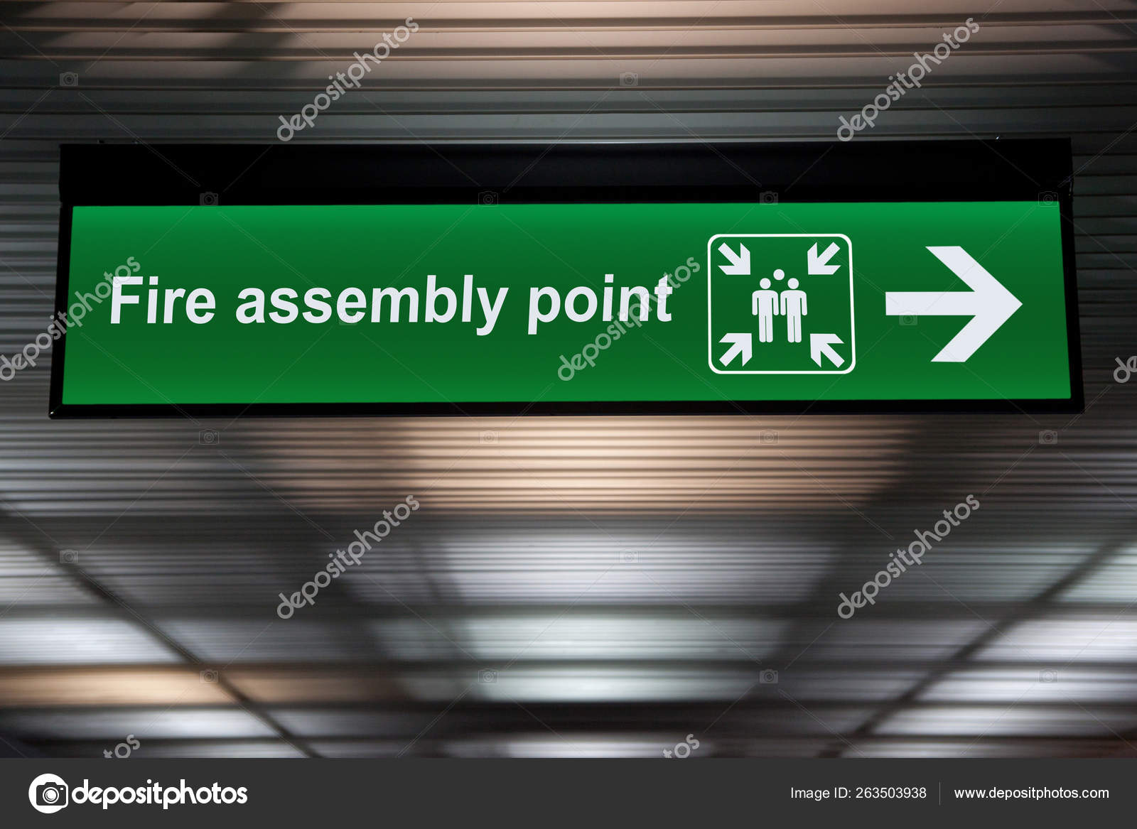 Green fire assembly point sign hanging from ceiling — Stock Photo ...