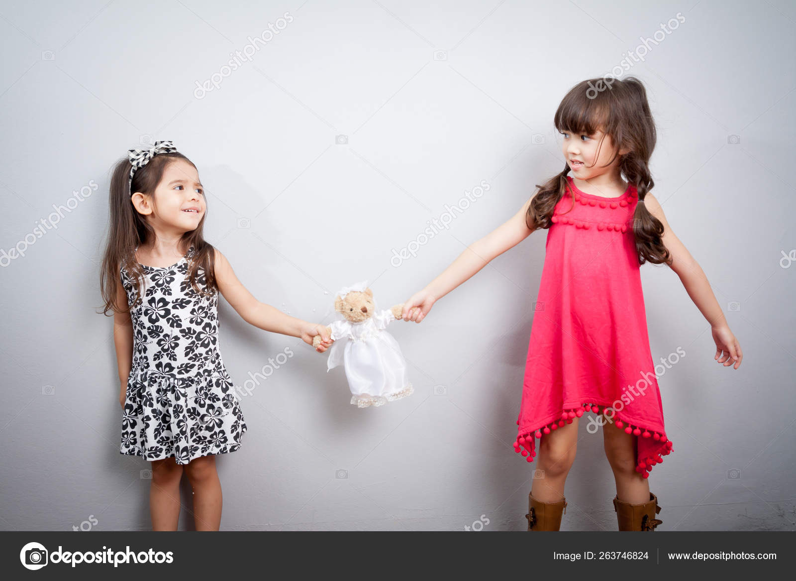 Two Kids Fighting Over A Toy