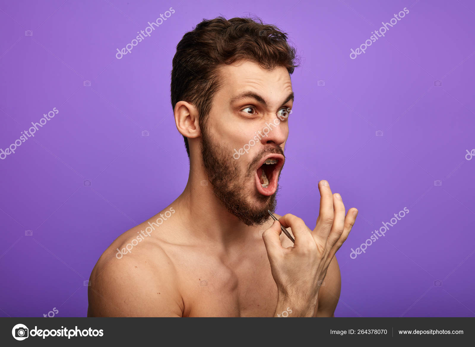 A suffering man plucking out his beard hair, standing isolated over ...