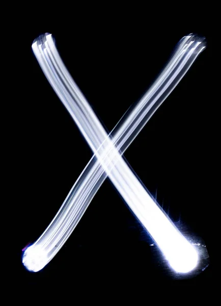 Handwrite letter X, made with light painting technic isolated on black ...