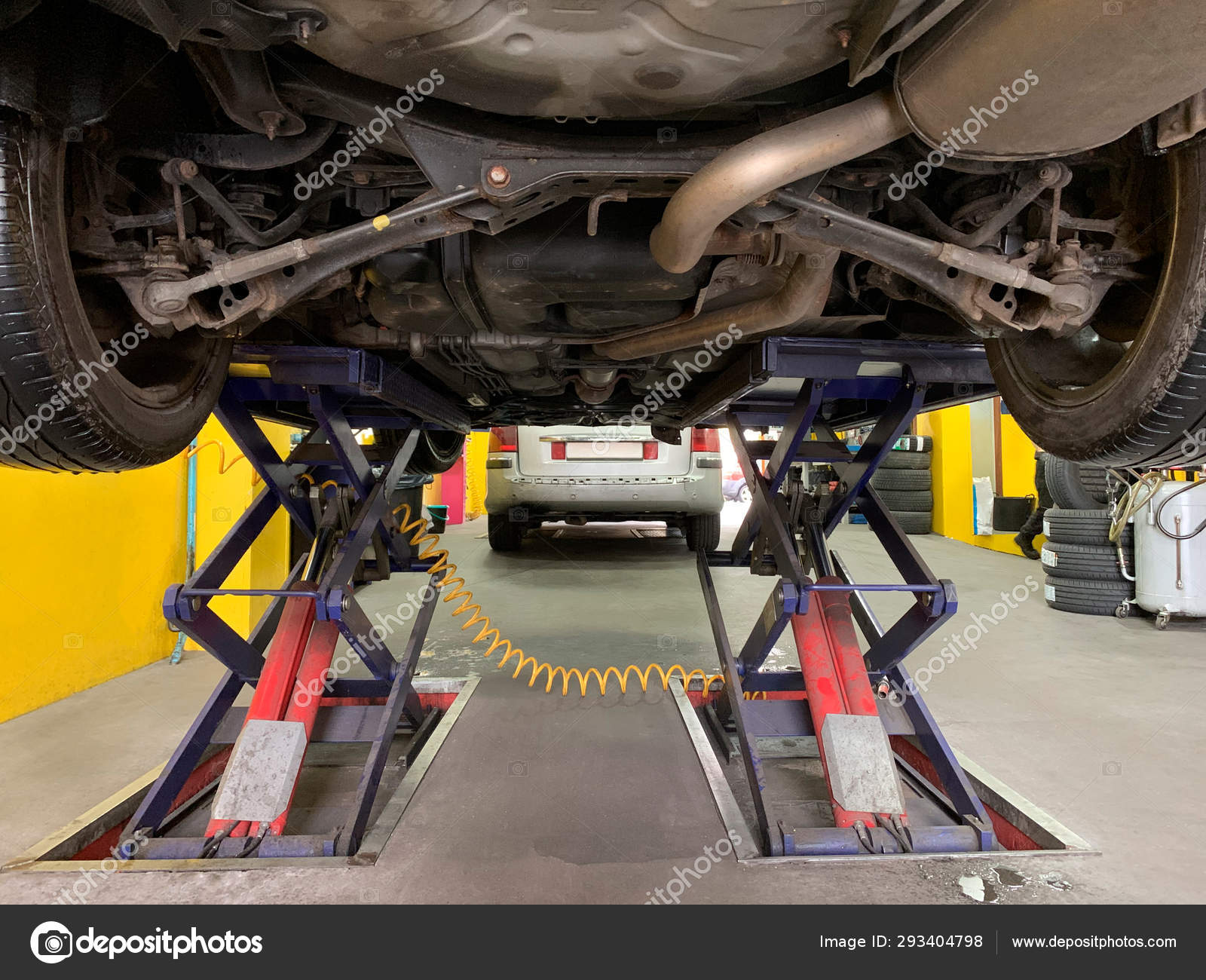 View of a car raised on a lift in a car repair shop, close-up — Stock ...