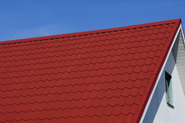 New red metal tiled roof house roofing construction exterior. Stock ...