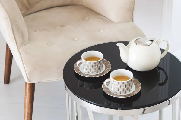 Two cups and tea cattle on a table. — Stock Photo © GolubtsovaAlex ...