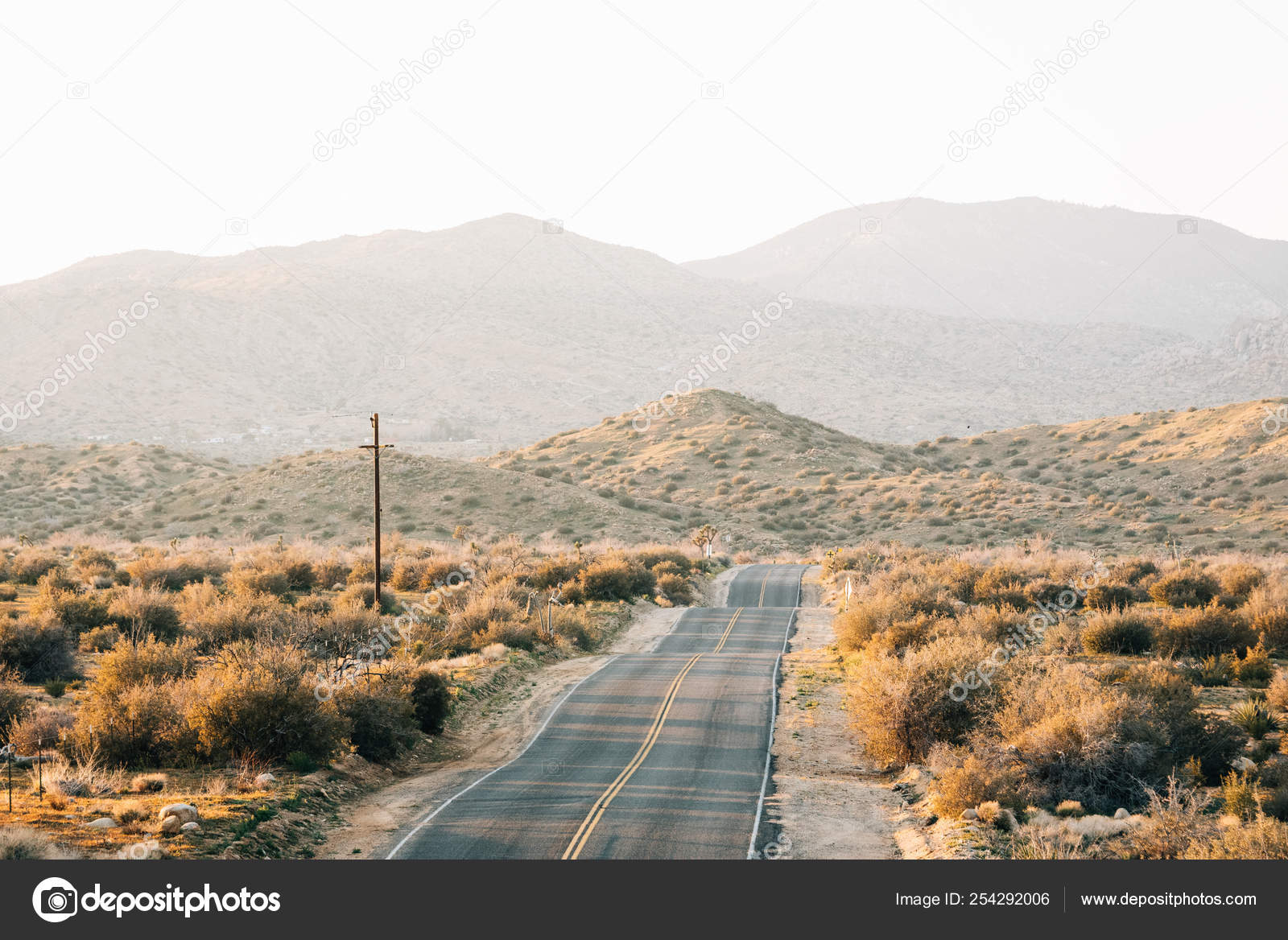 A hilly road and mountains in the desert, in Pioneertown, Califo ...
