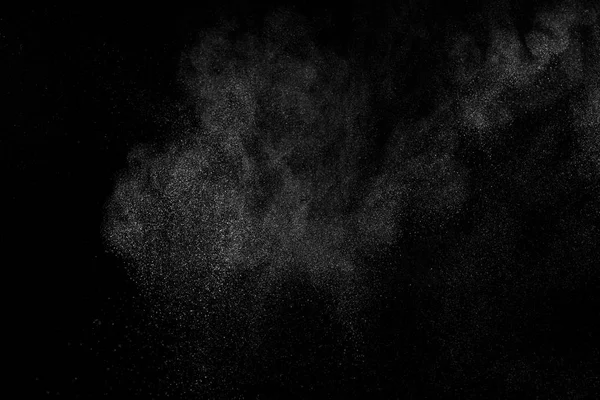 Freeze motion of white particles on black background. Powder explosion ...