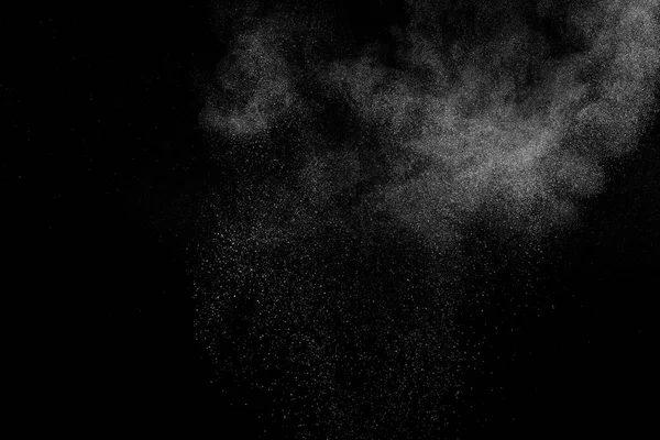 Freeze motion of white particles on black background. Powder explosion. Abstract dust overlay ...