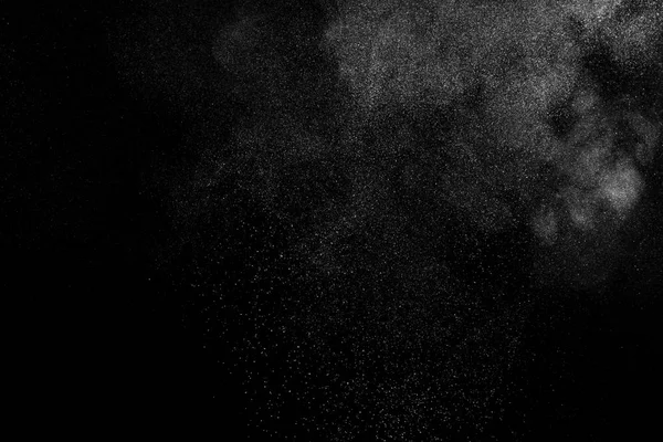 Freeze motion of white particles on black background. Powder explosion ...