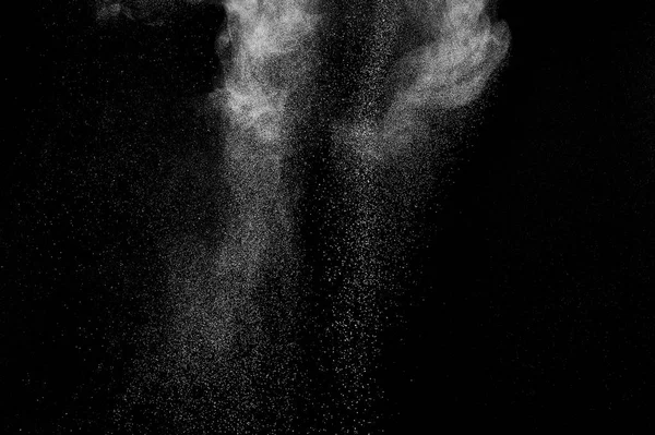 Freeze motion of white particles on black background. Powder explosion ...