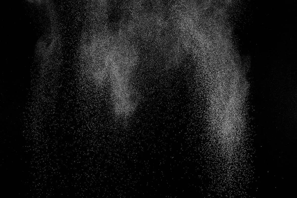 Freeze motion of white particles on black background. Powder explosion ...