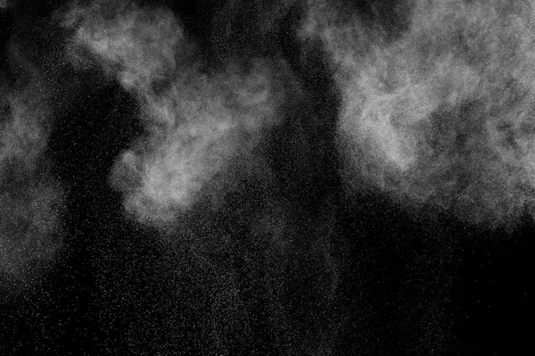 Freeze motion of white particles on black background. Powder explosion ...