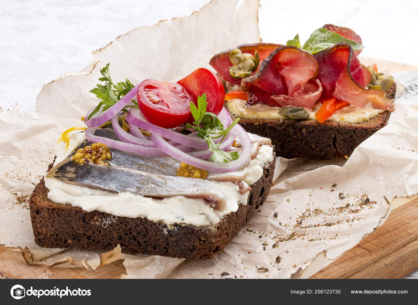 Toasts with venison, pepper and capers, herring and ricotta cheese ...