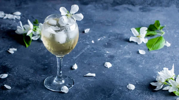 Apple alcoholic cocktail with sparkling wine in glass on a dark ...