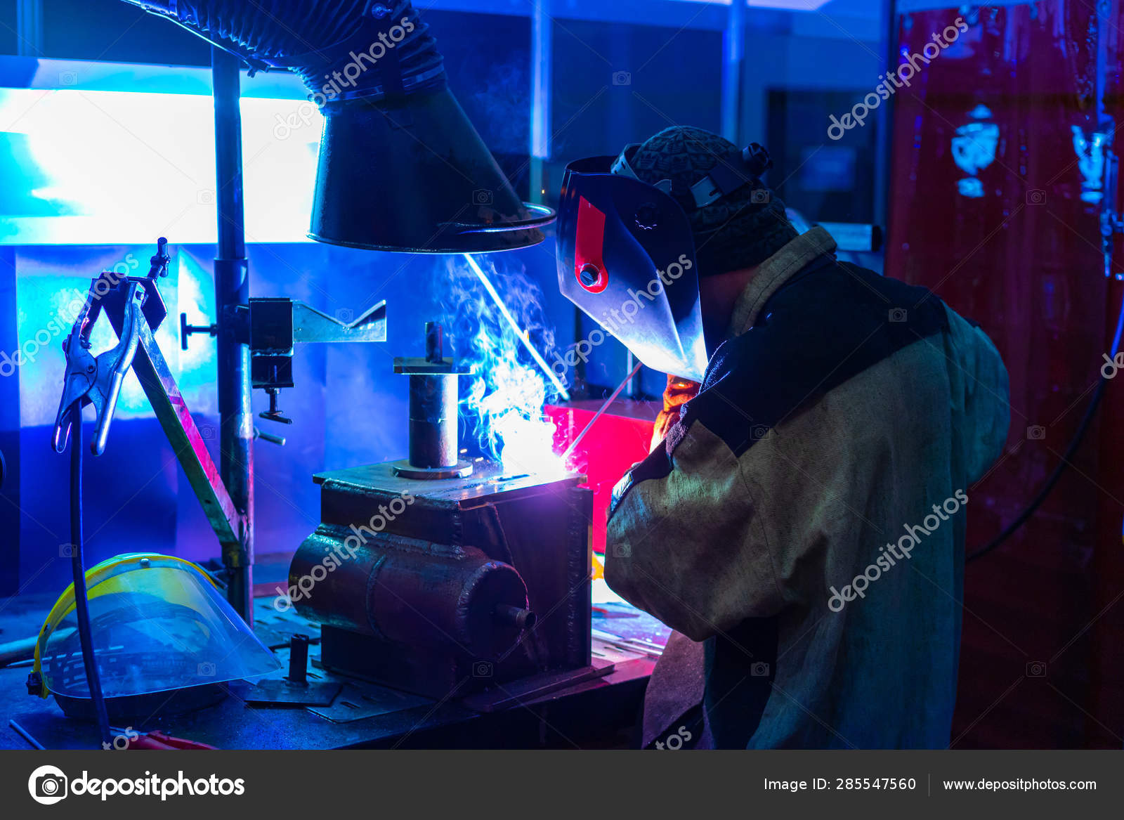 A man works on a welding machine. The welding process at the factory ...