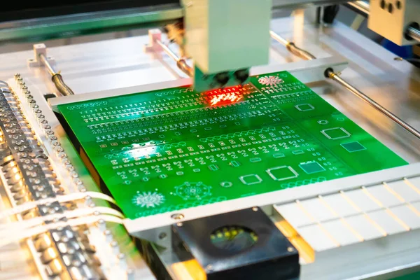 Production of printed circuit boards. The machine assembles the printed ...