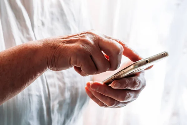 Older woman hands. Using touch screen phone. Old people and technology ...