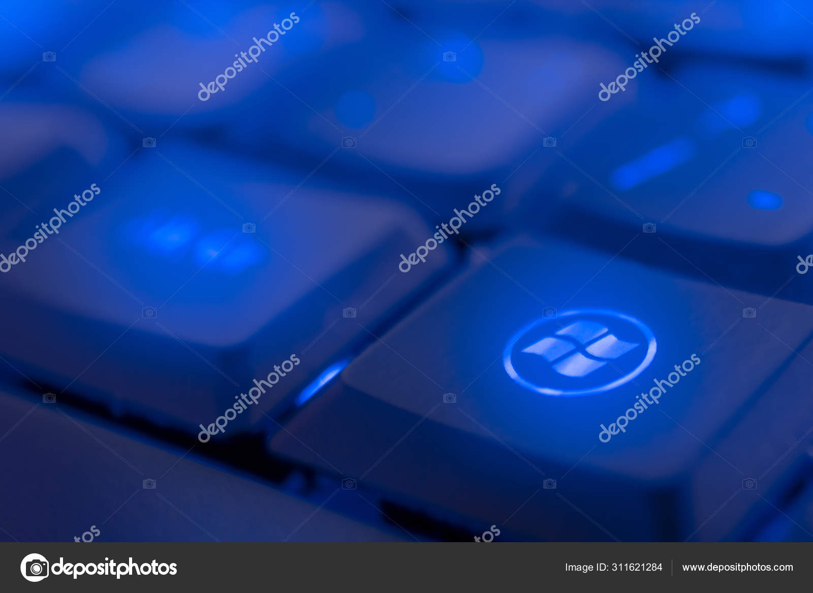 WINDOWS key illuminated by blue LED light. Close-up of keyboard ...