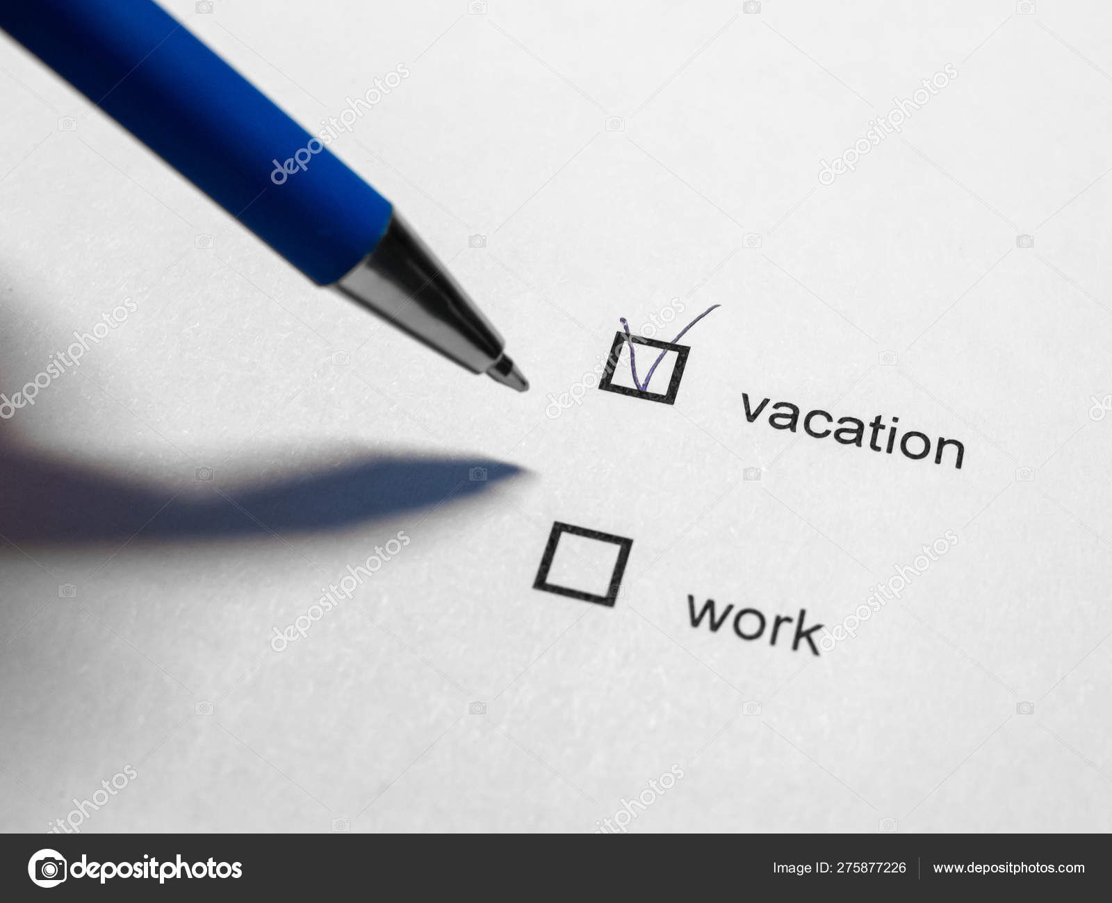 Vacation or work - tick on white paper with pen. The concept of ...