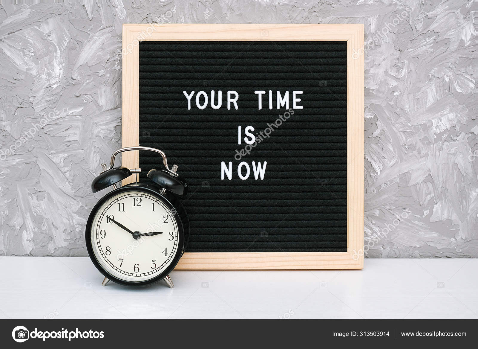 Your time is now. Motivational quote on letter board and black alarm ...