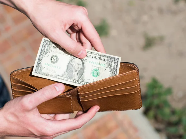 last one dollar money banknote in wallet. bankrupt concept. close up ...