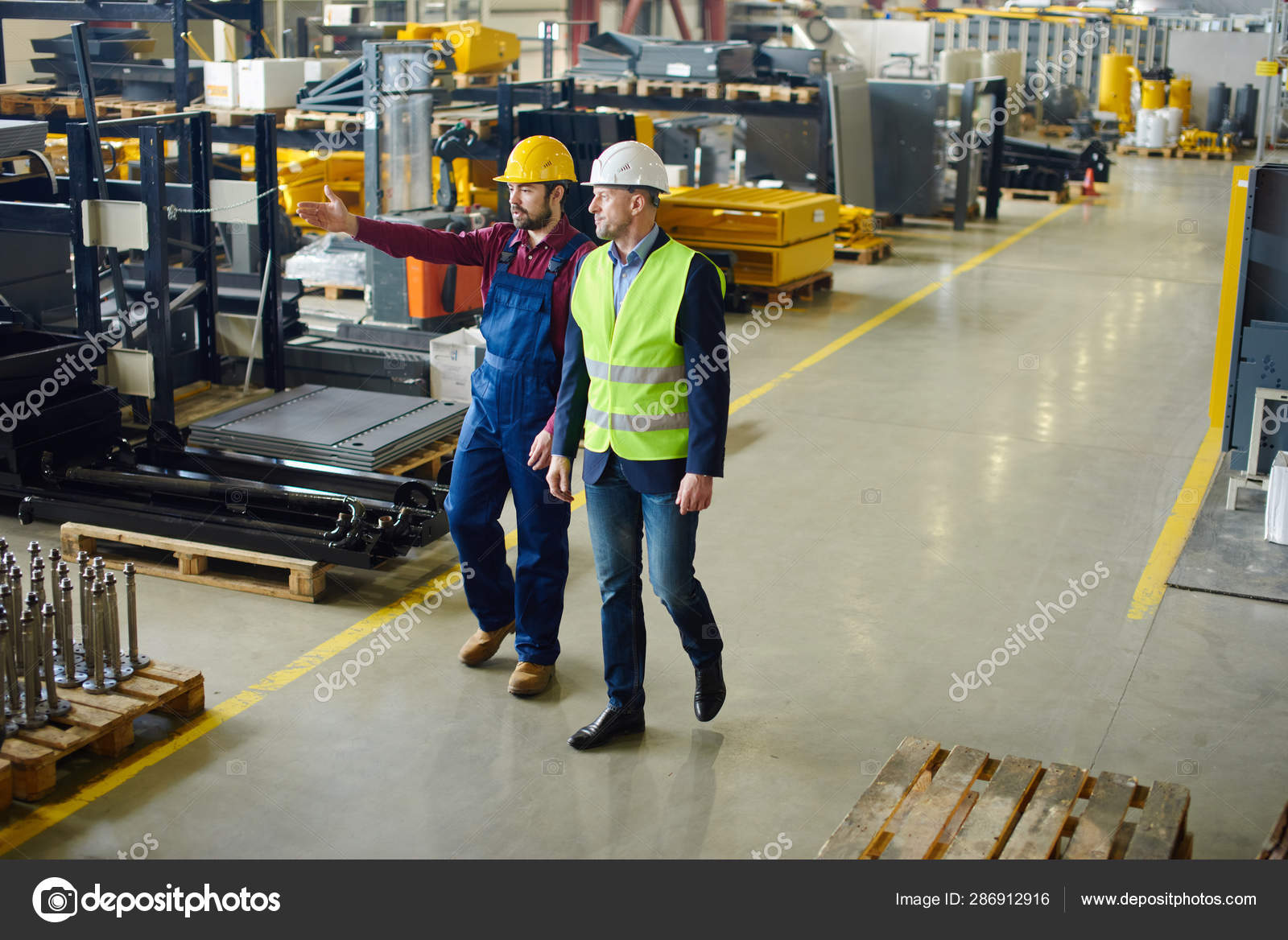 Engineers walking along the plant they work at shot from distance ...