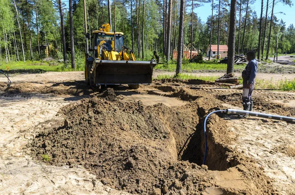 the work of a large two-wheeled tractor when laying water supply for ...