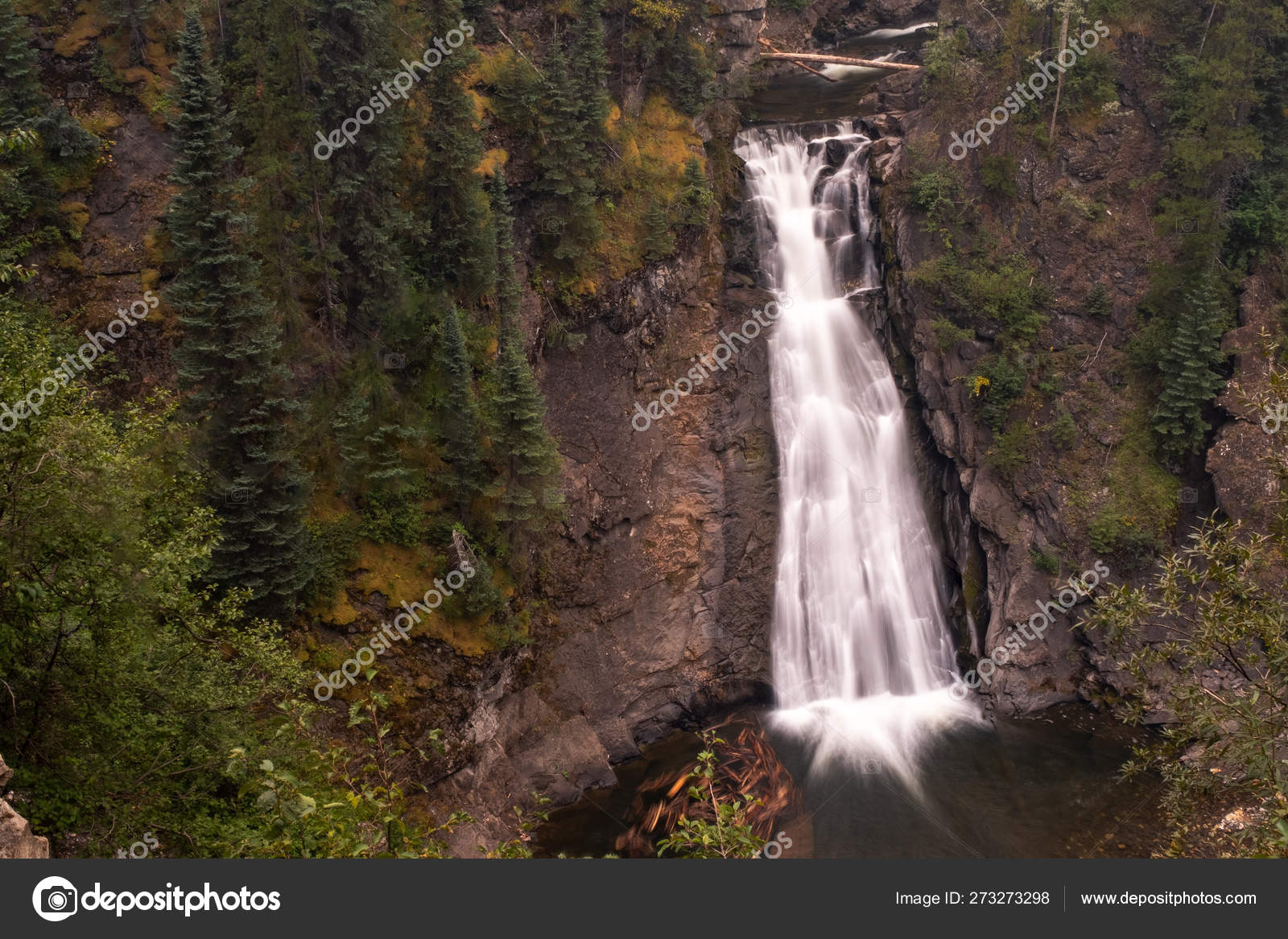 A distant view of a majestic waterfall in Monkman Provincial Park ...