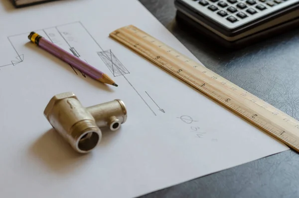 Sheet of paper with a drawing of the home water supply on the table ...