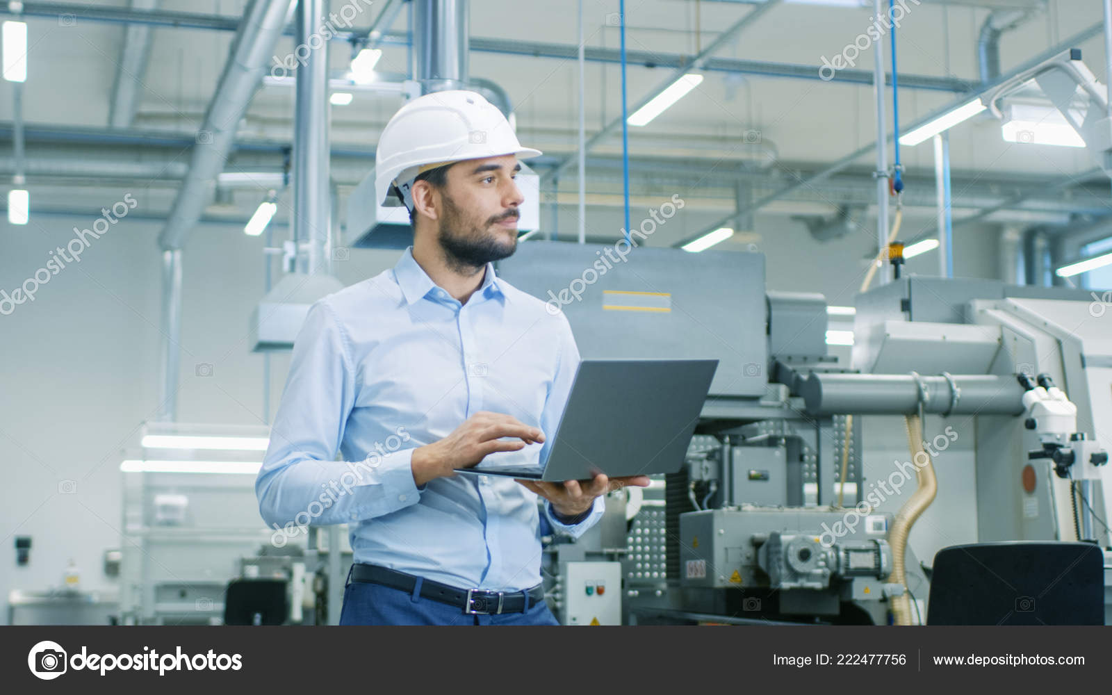 Chief Engineer Hard Hat Walks Light Modern Factory While Holding Stock ...